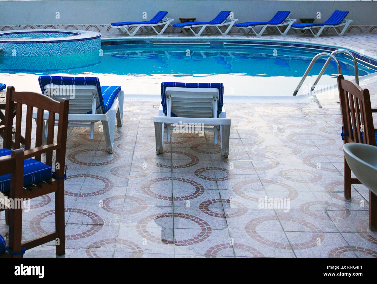 Blue Pool and Recliners with no people Stock Photo - Alamy