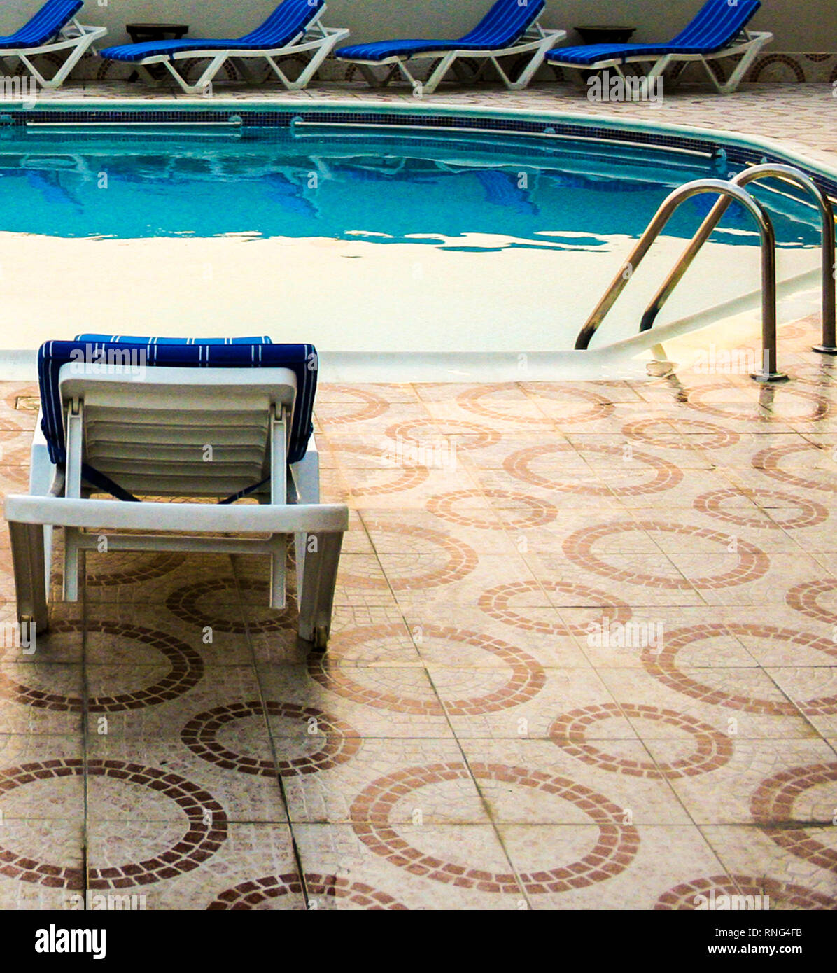 Blue Pool and Recliners Stock Photo - Alamy