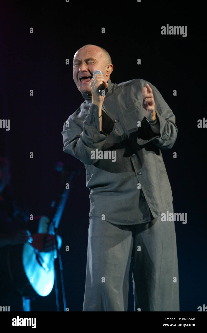 Musician Phil Collins is shown performing on stage during a "live ...