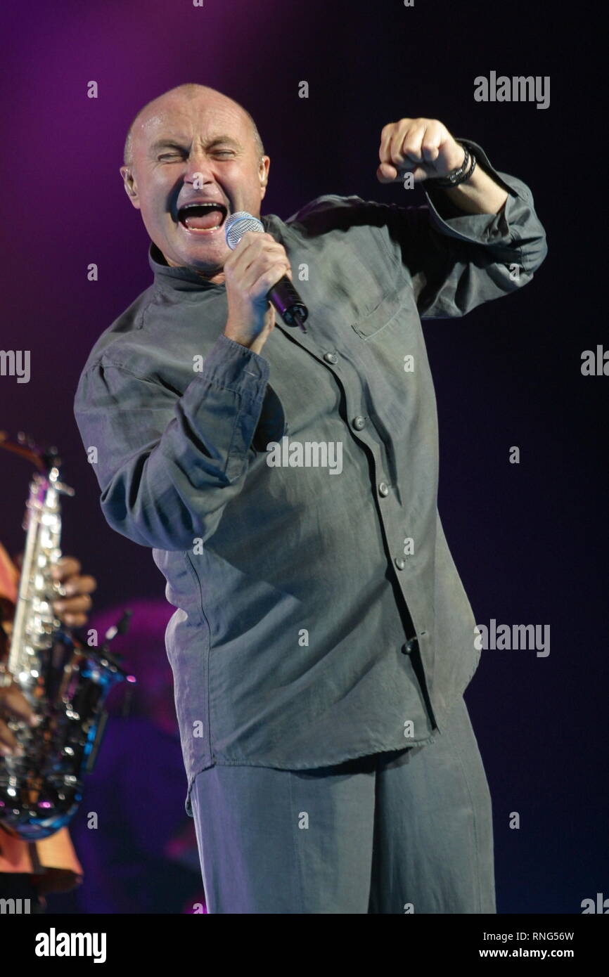 Musician Phil Collins is shown performing on stage during a "live ...