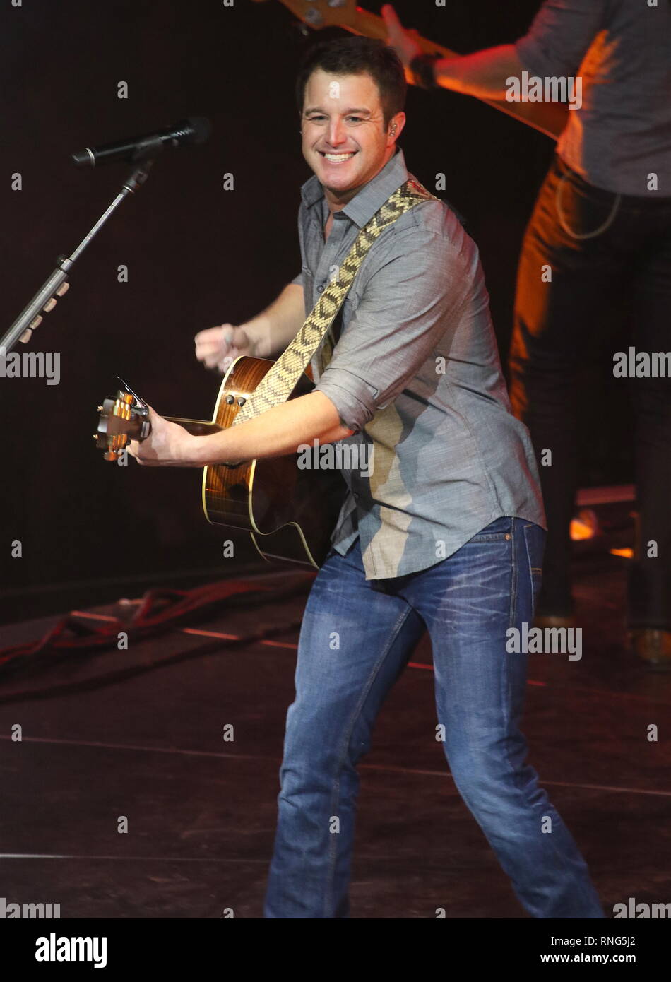 Musician Easton Corbin is shown performing on stage during a "live ...