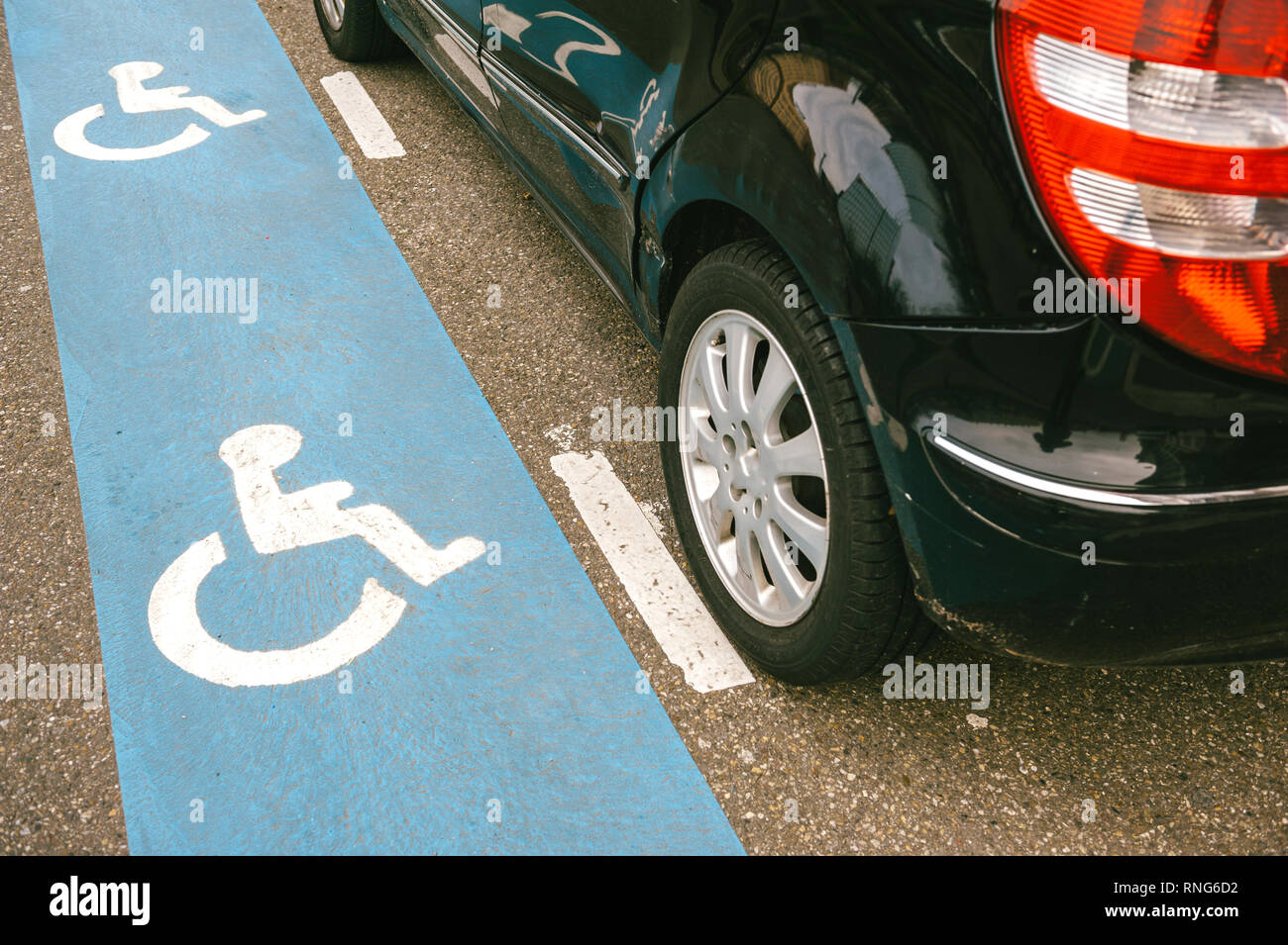 Black car parked on the disabled blue sign during the day Stock Photo ...
