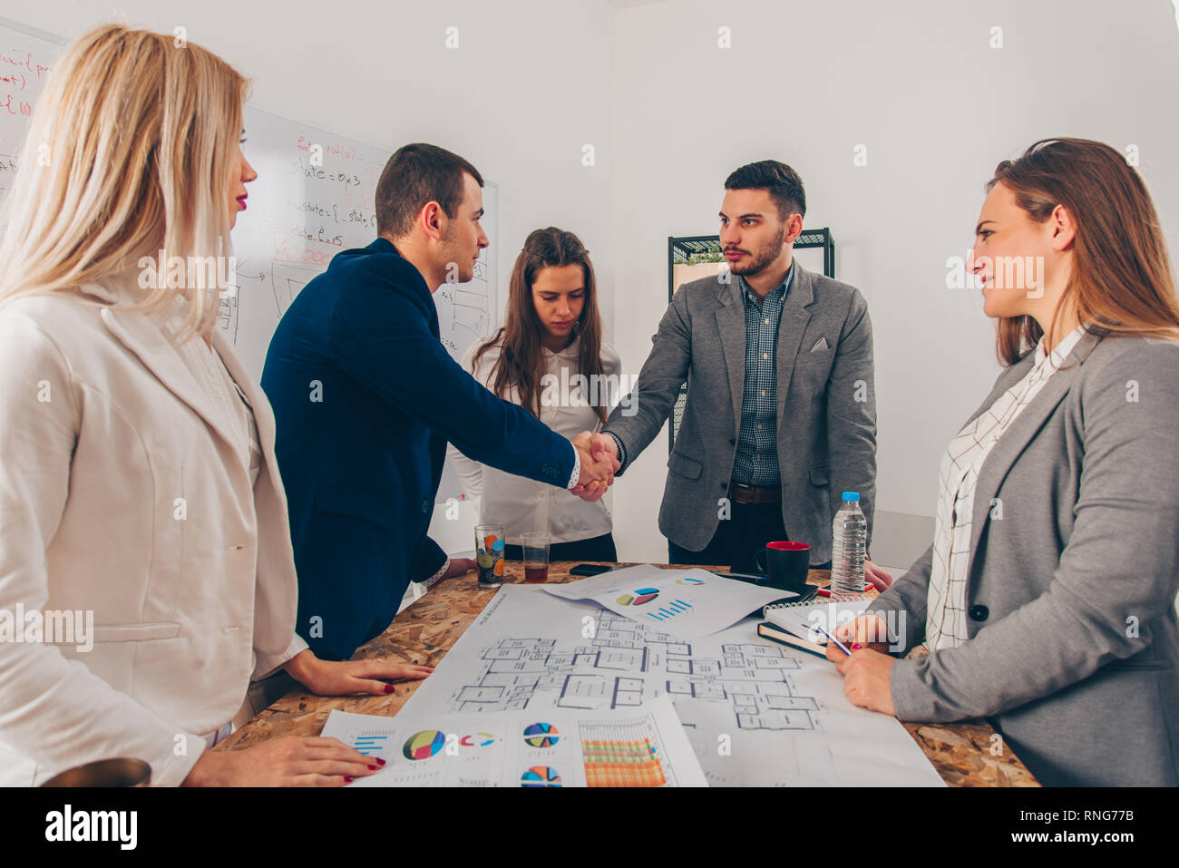 Two young architects are making a work deal Stock Photo - Alamy