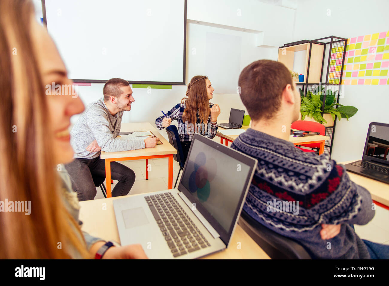 Group of teens are on class, smiling and talking Stock Photo - Alamy