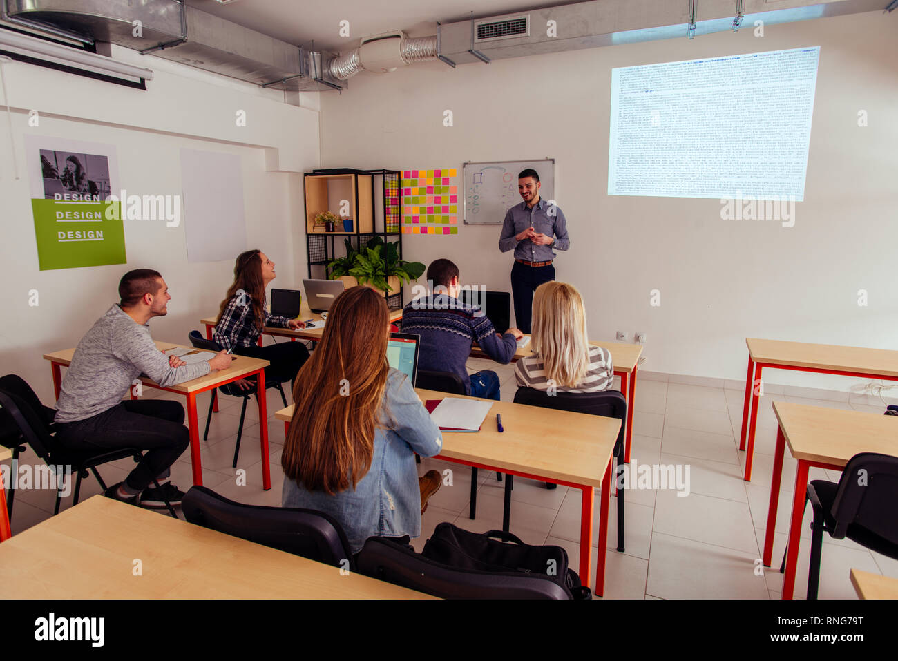 Teacher in classroom, students listening to a lecture Stock Photo - Alamy