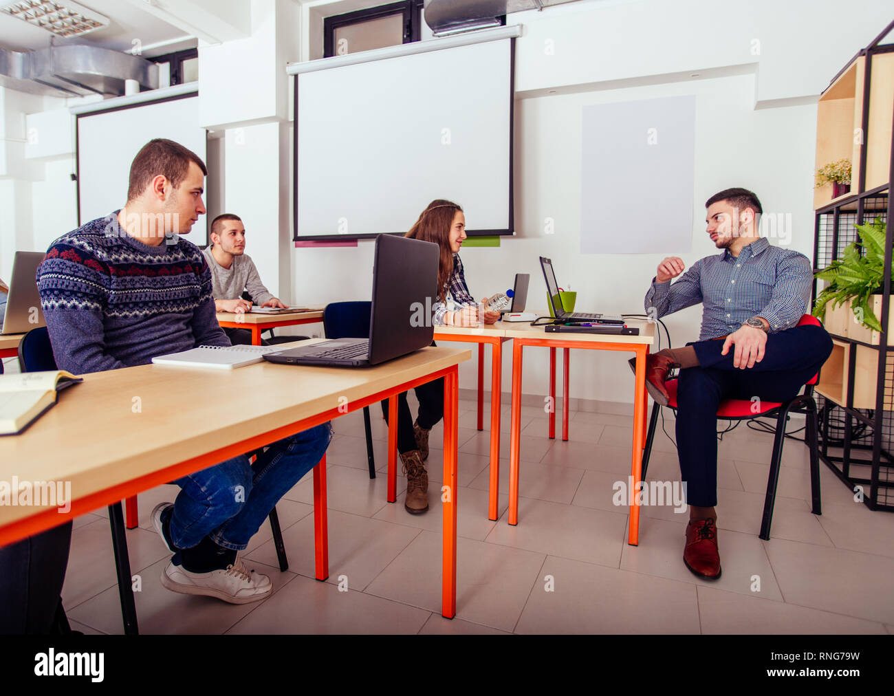 Urban students are listening to a lecture and discussing on class Stock ...