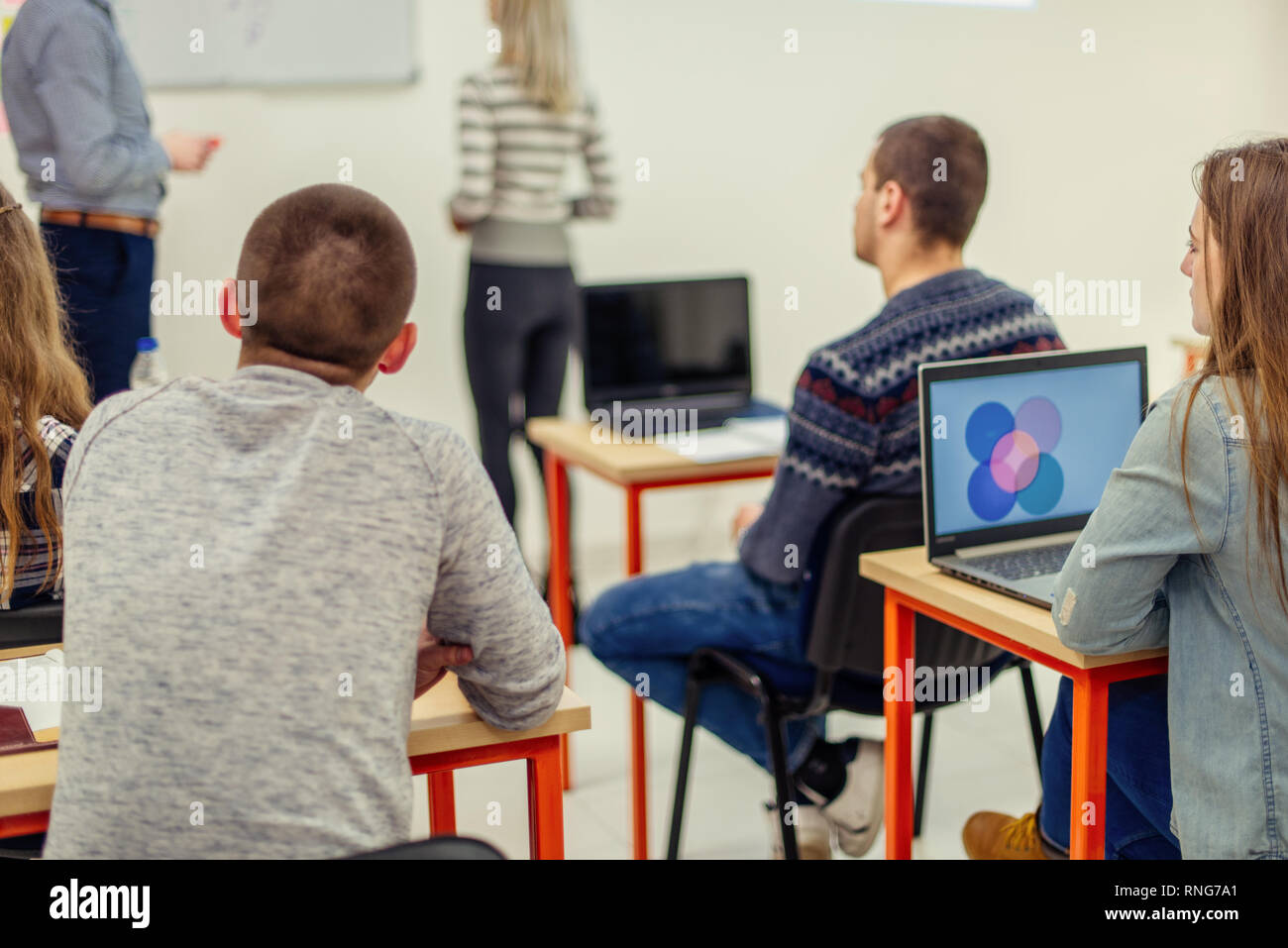 Group of students are in school, they are studying and looking at their ...