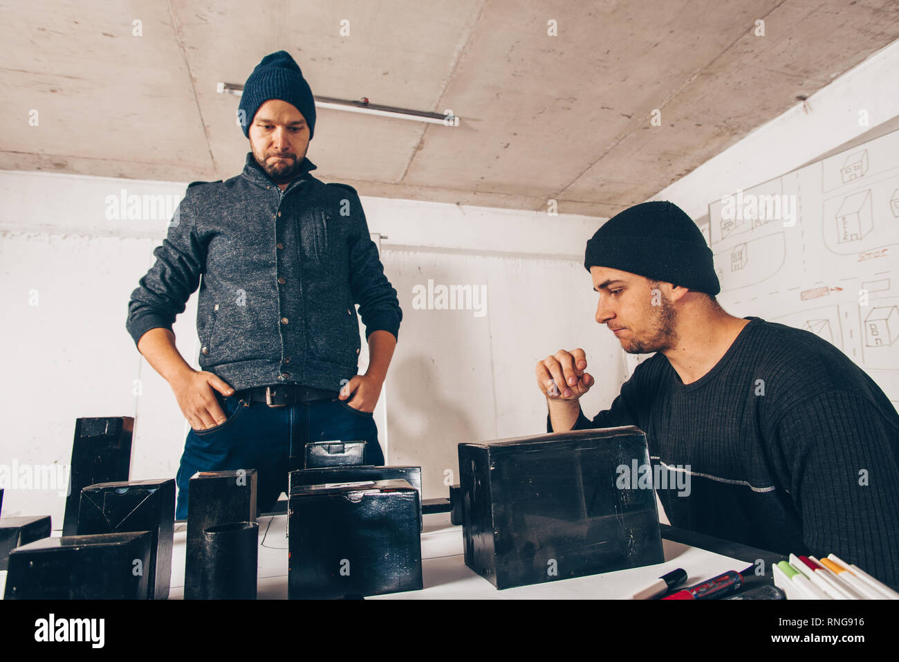 Male persons are sitting in a room with maps and they are preparing for ...