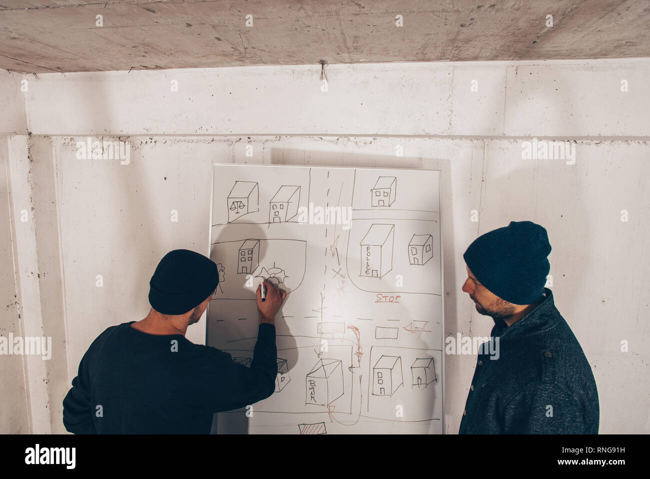 Dangerous thiefs standing in a room and making a plan for heist Stock ...