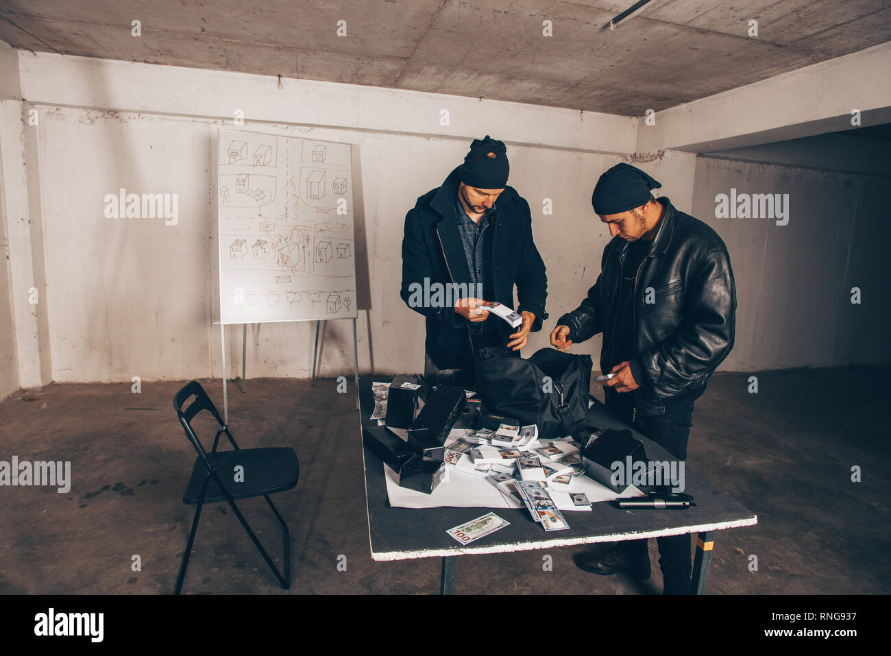 Gangsters are counting money in a basement Stock Photo - Alamy