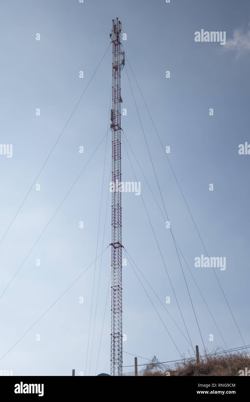 Very high mobile tower against the blue sky Stock Photo - Alamy