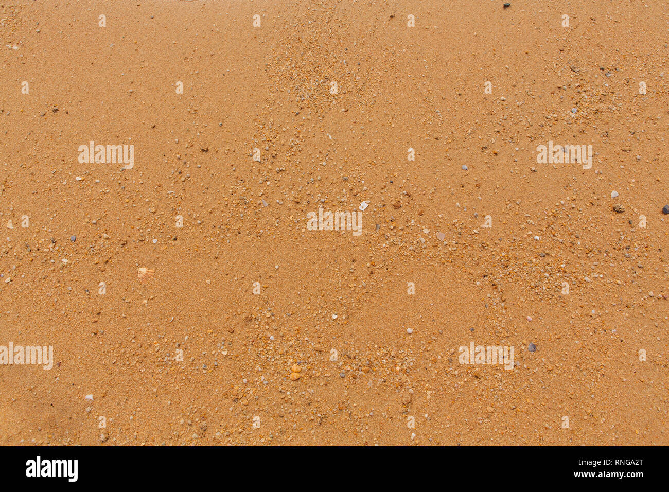 Yellow sand and small stones texture and background Stock Photo - Alamy