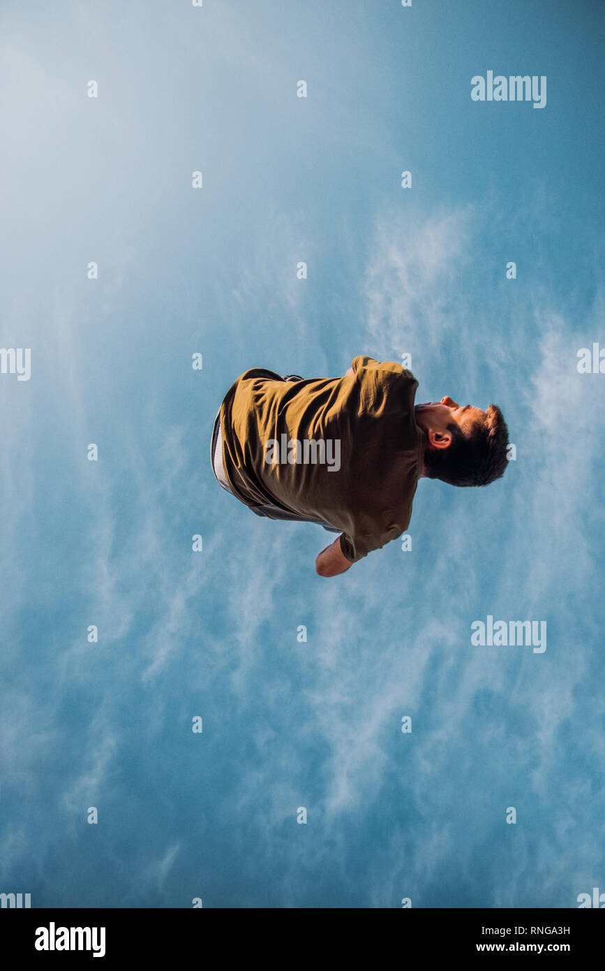 Sporty man make risky stunt while jumping high in the air Stock Photo ...