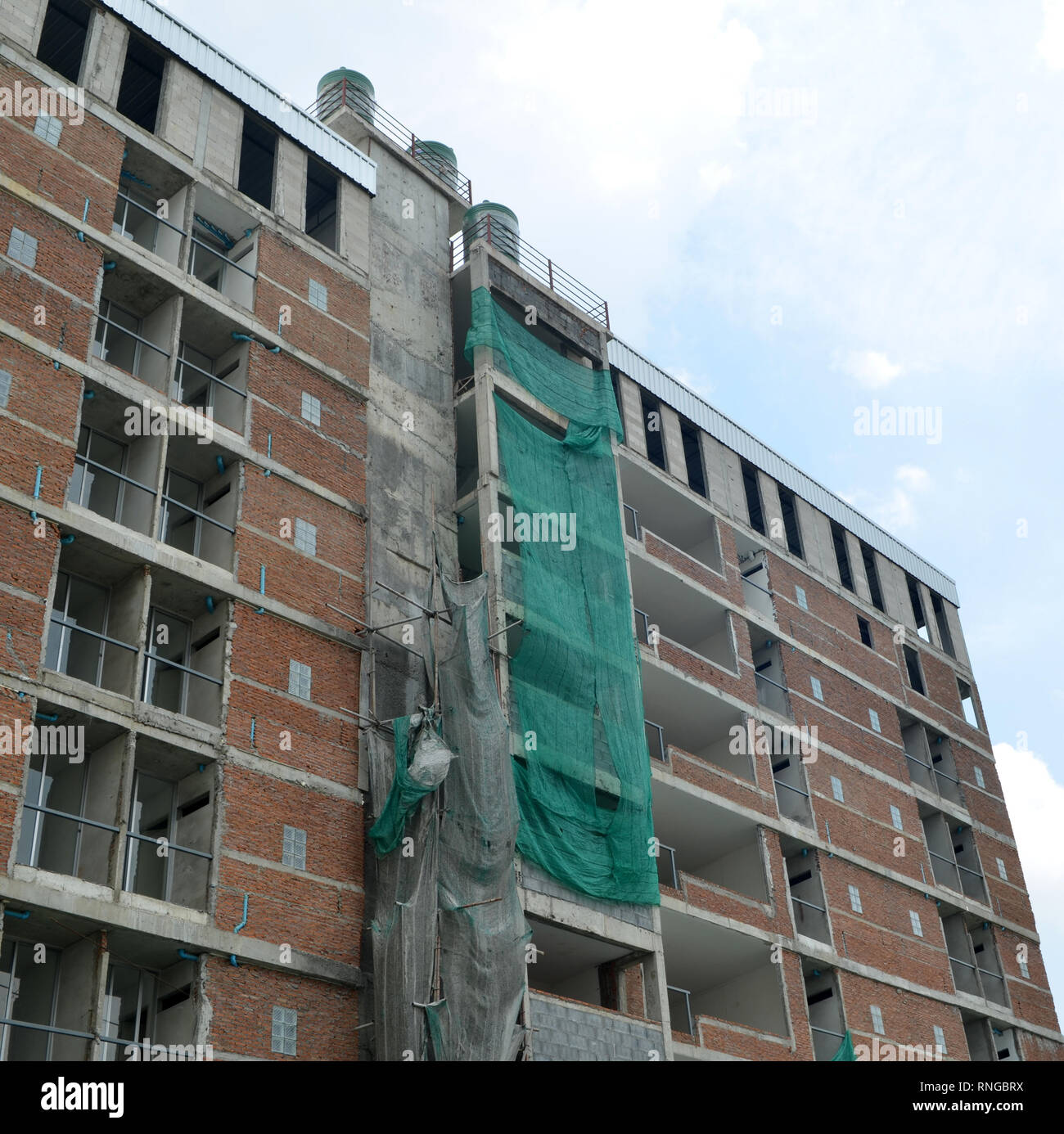 Low-angle view of a tall commercial building under construction against ...