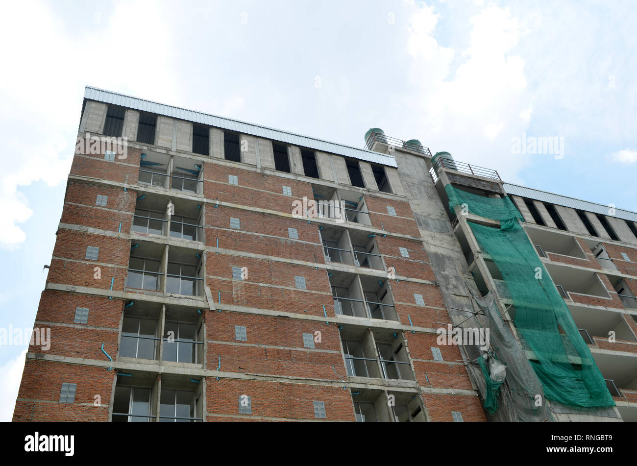 Low-angle view of a tall commercial building under construction against ...