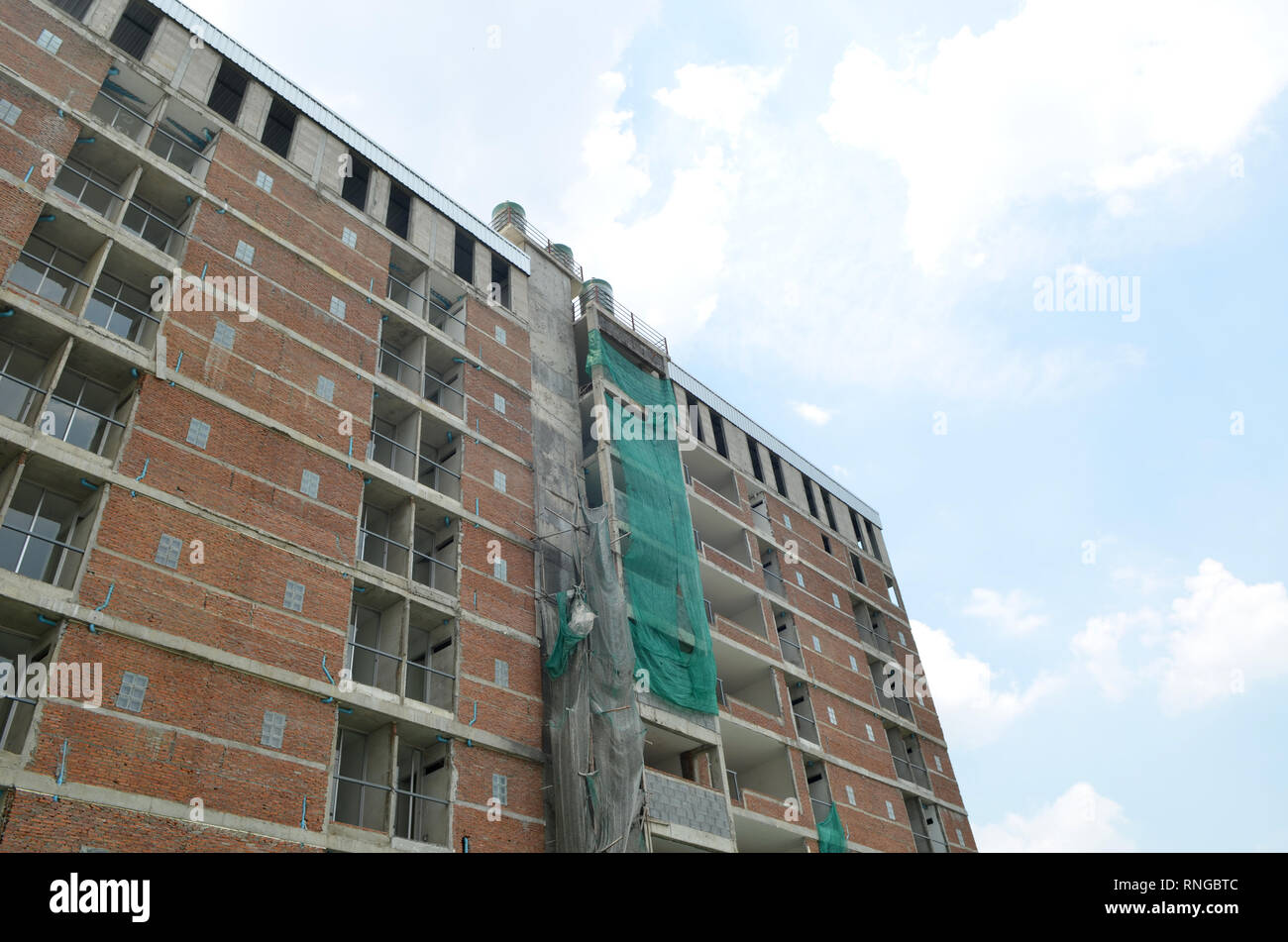 Low-angle view of a tall commercial building under construction against ...