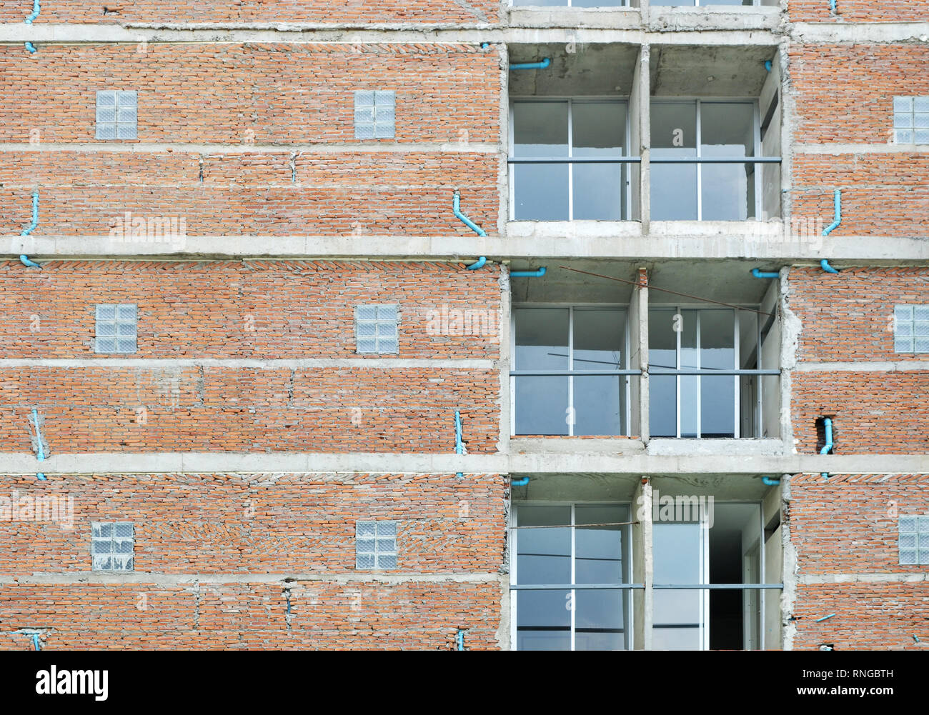 Low-angle view of a tall commercial building under construction against ...