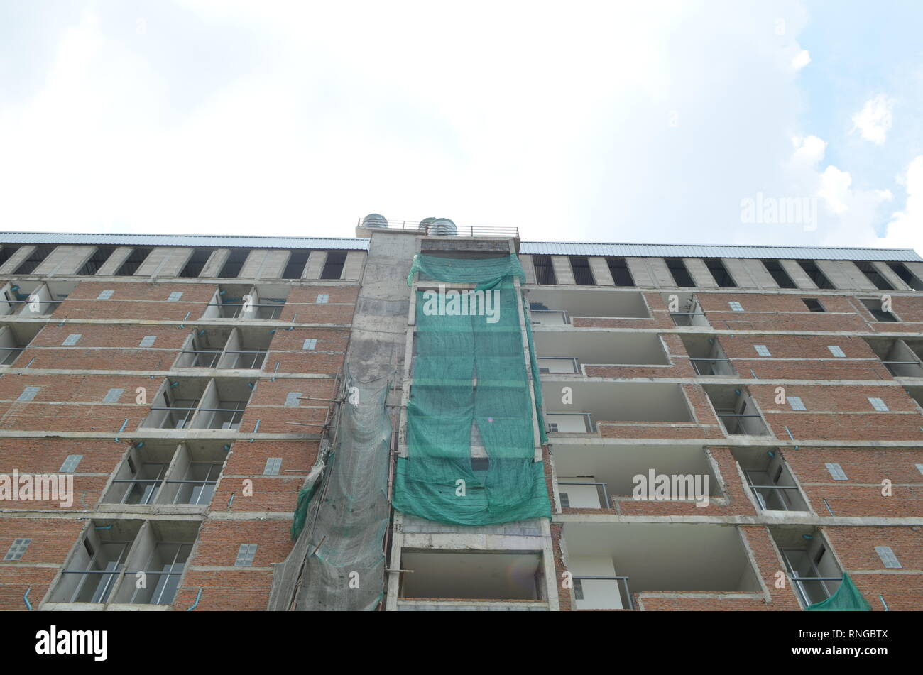 Low-angle view of a tall commercial building under construction against ...