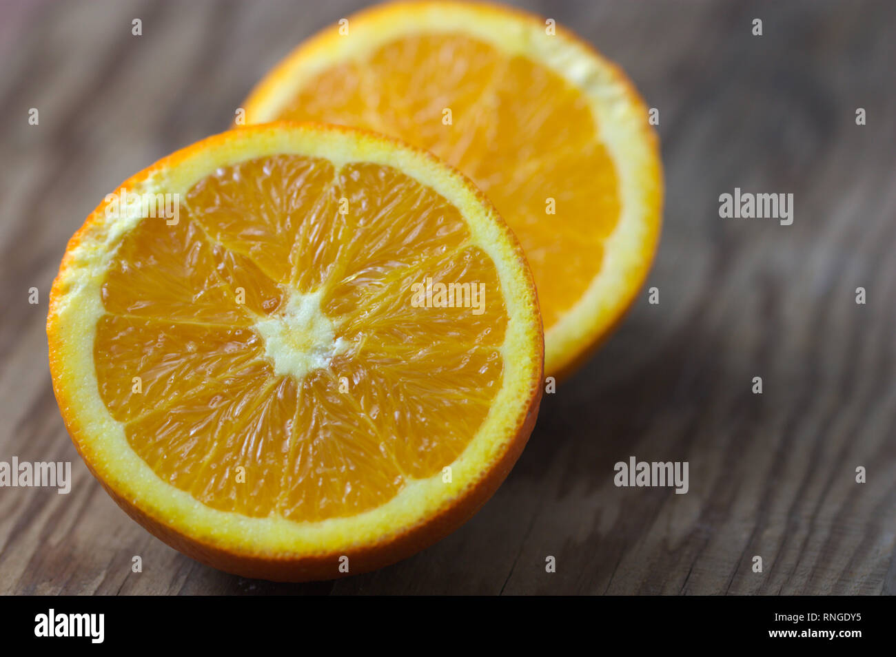 On an old wooden table we see the detail of the interior of an orange ...