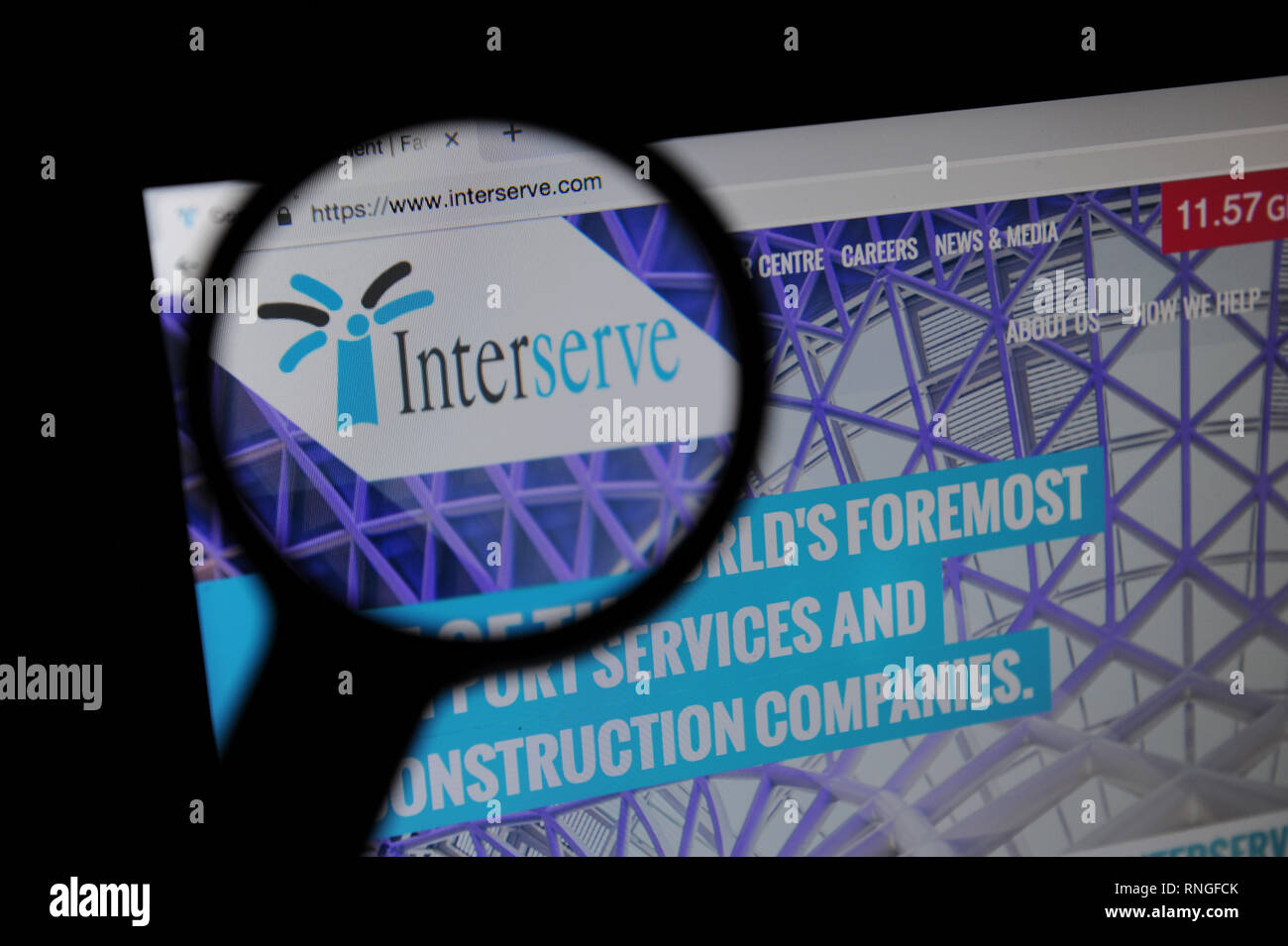 The Interserve website seen through a magnifying glass Stock Photo - Alamy