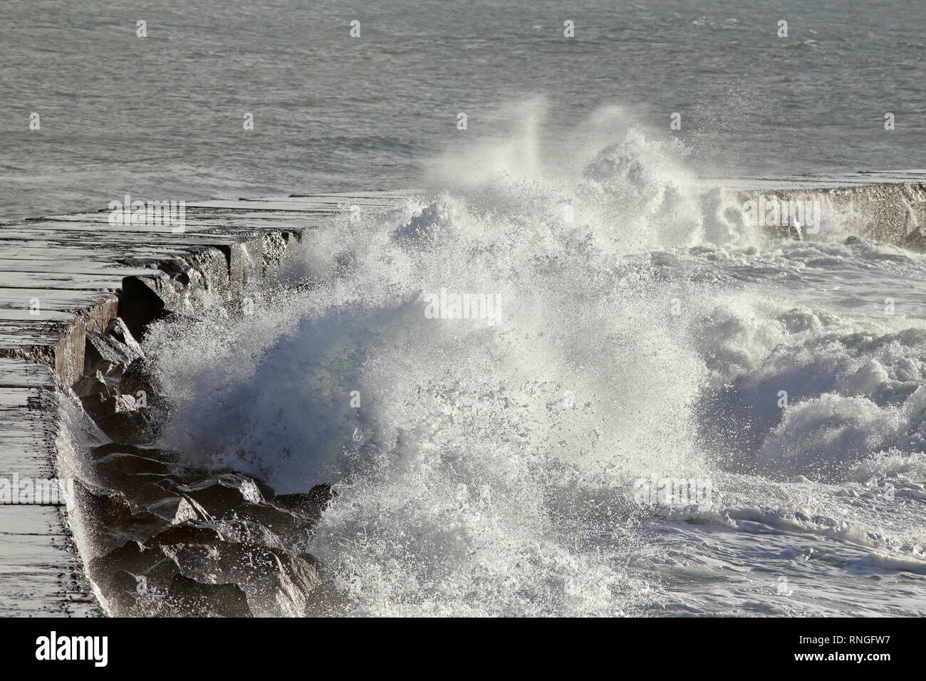 Strong waves against river mouth pier Stock Photo - Alamy