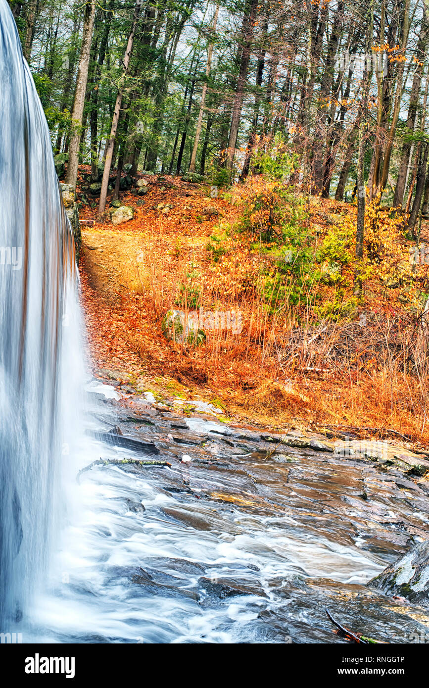 A waterfall flowing over a stone wall at Burr Pond Torrington ...