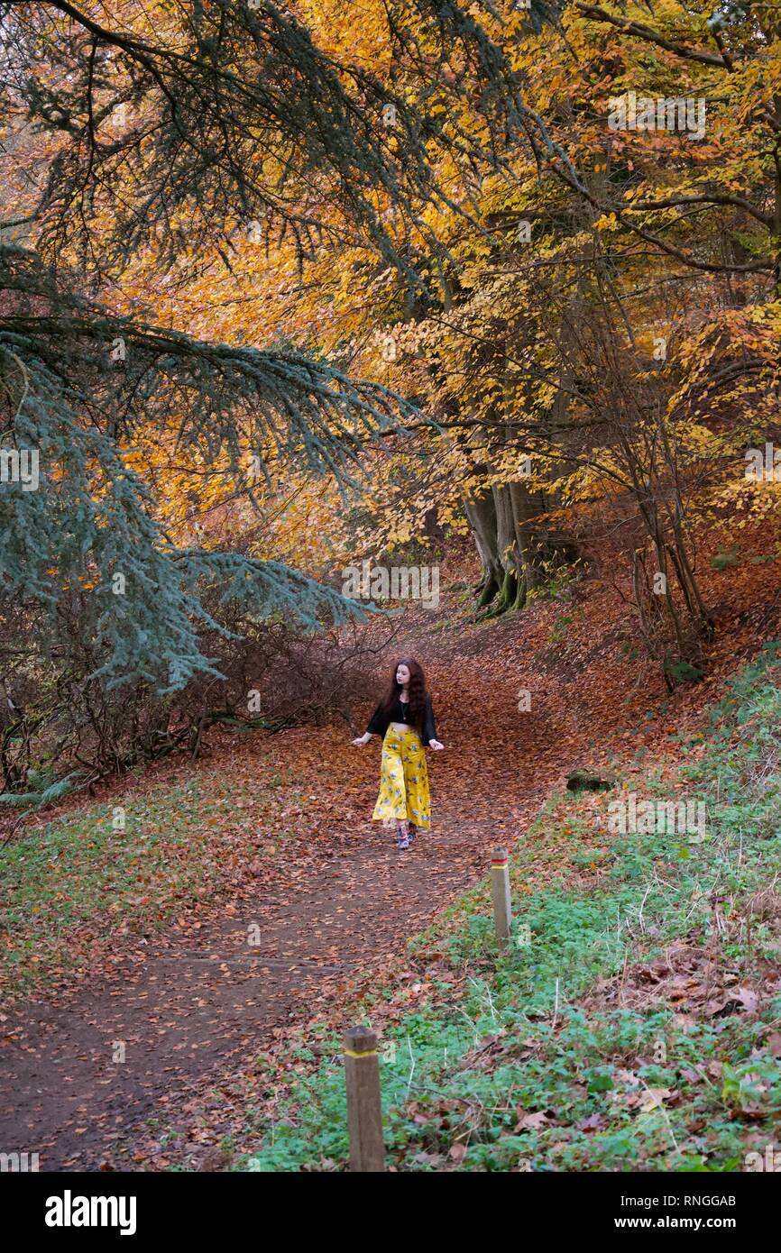 A long haired brunette, caucasian lady wearing fashionable yellow ...