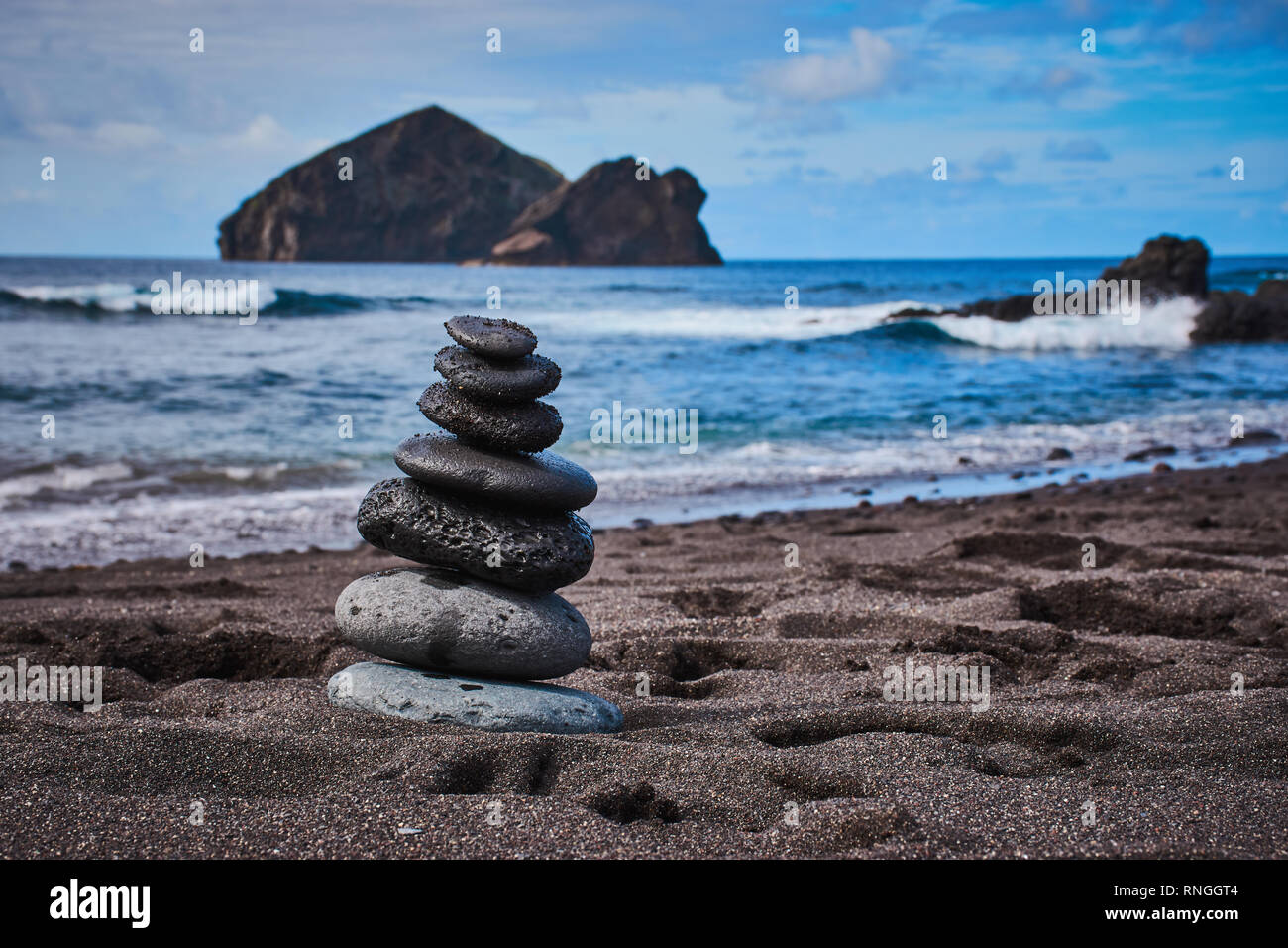 stone tower in front of the volcanic rocks of Mosteiros beach, Sao ...