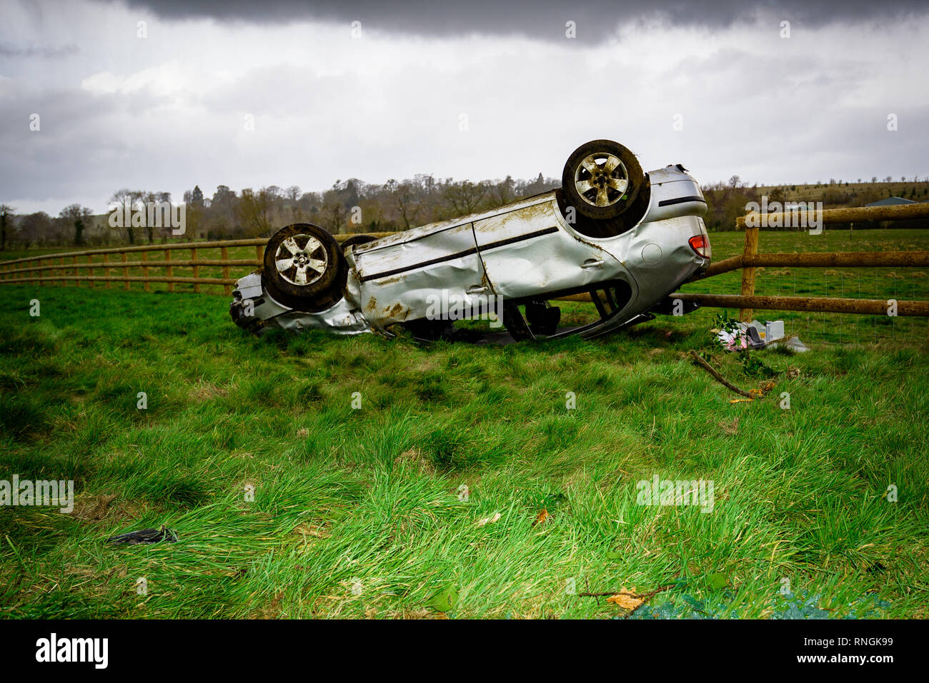 Car Crash and Car Damage. Vehicle upside down in a field surrounded by ...