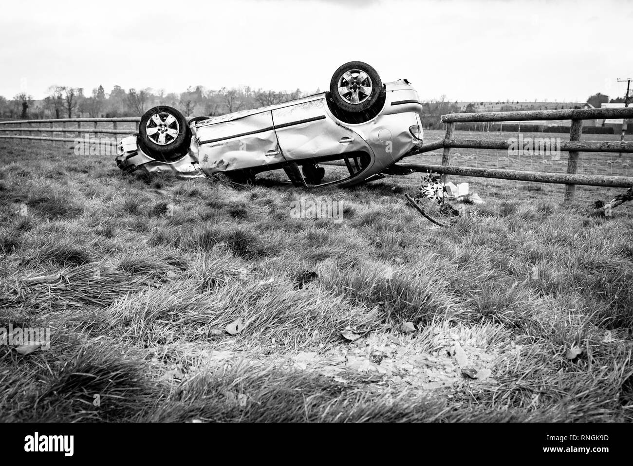 Car Crash and Car Damage. Vehicle upside down in a field surrounded by ...