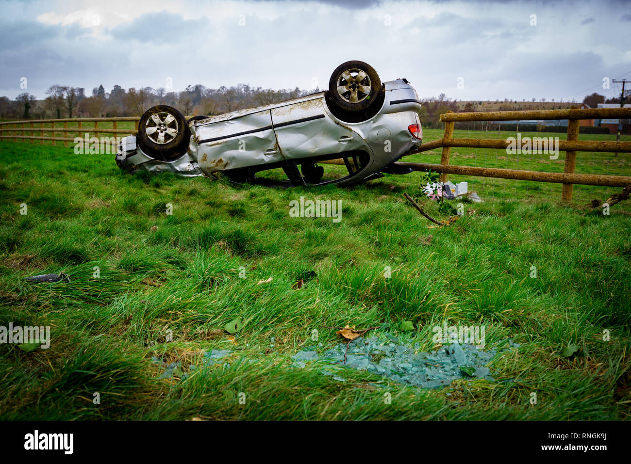 Car Crash and Car Damage. Vehicle upside down in a field surrounded by ...