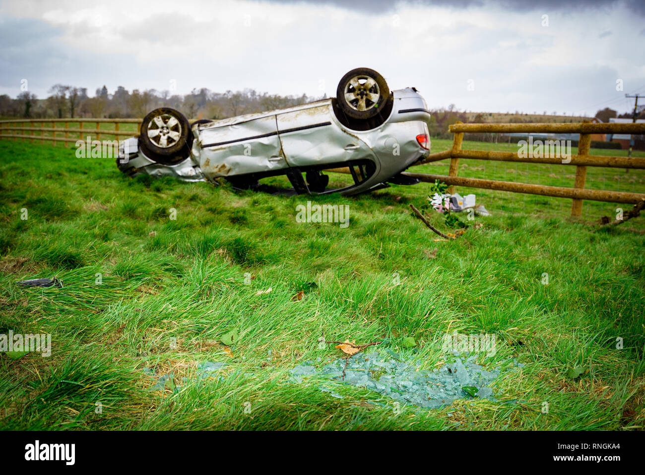 Car Crash and Car Damage. Vehicle upside down in a field surrounded by ...