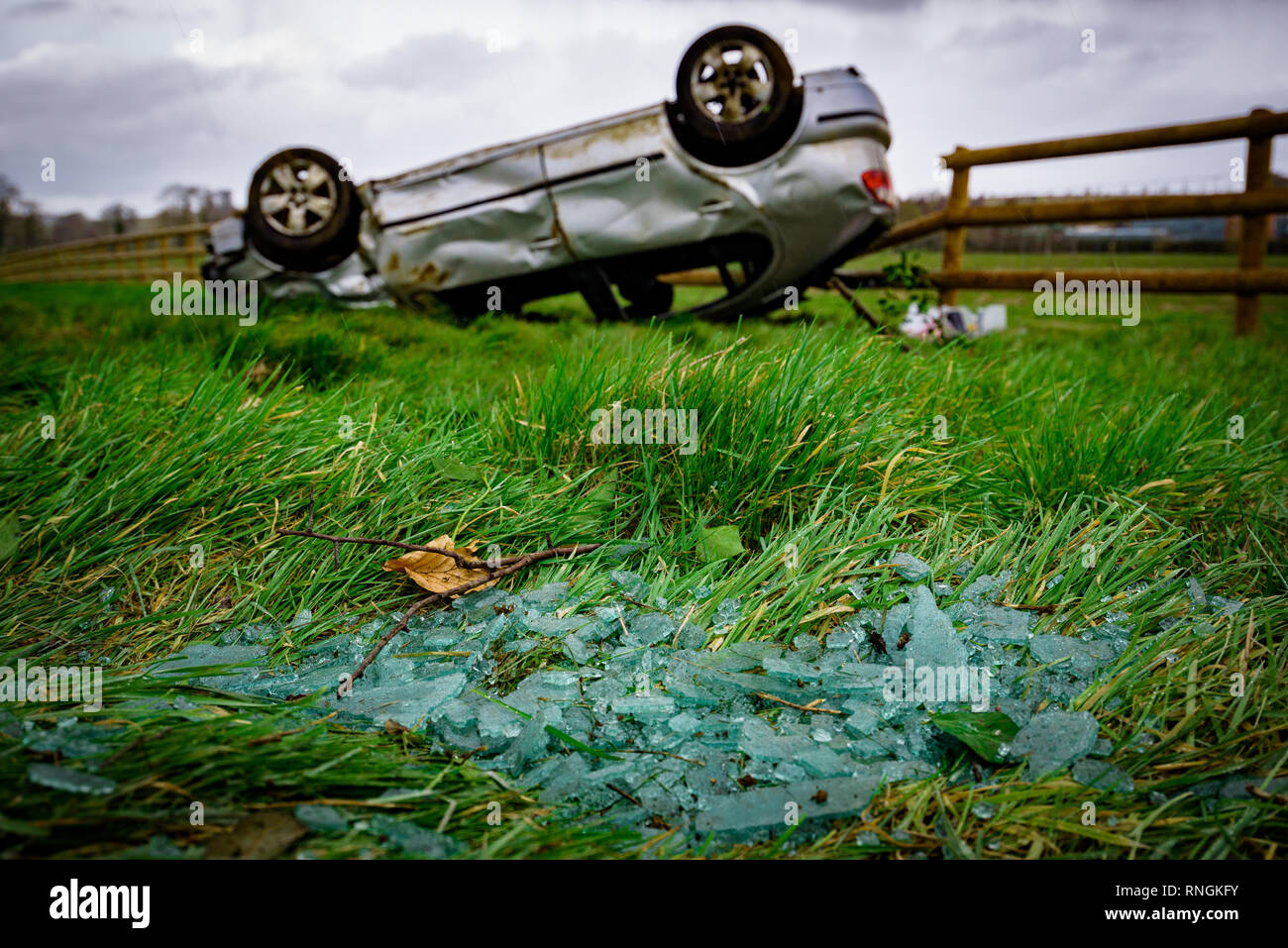 Car Crash and Car Damage. Vehicle upside down in a field surrounded by ...