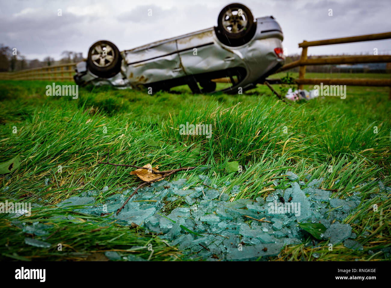 Car Crash and Car Damage. Vehicle upside down in a field surrounded by ...