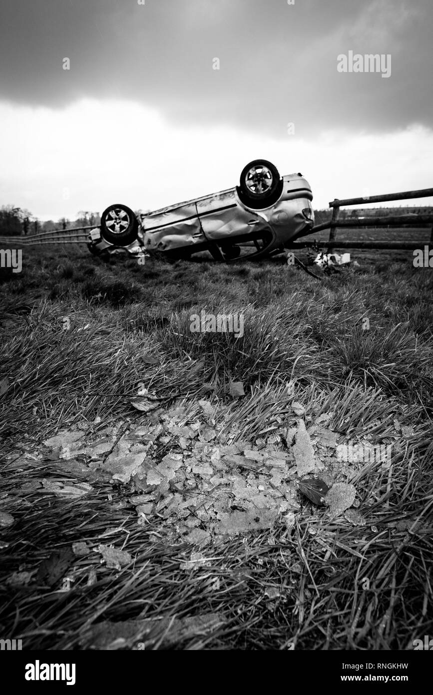 Car Crash and Car Damage. Vehicle upside down in a field surrounded by ...