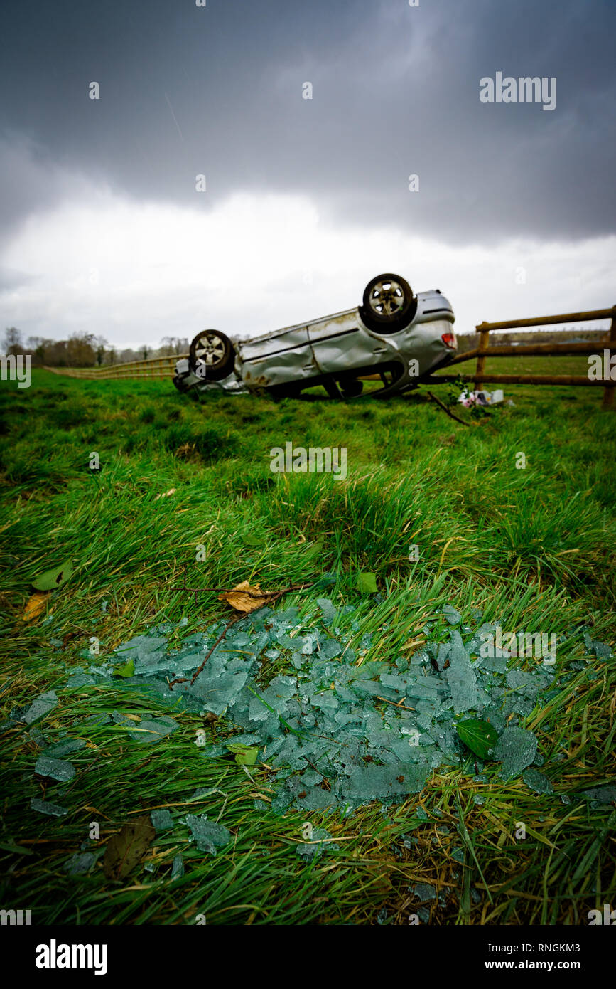 Car Crash and Car Damage. Vehicle upside down in a field surrounded by ...