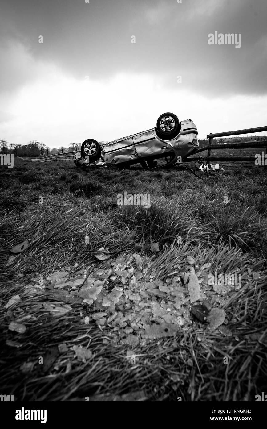Car Crash and Car Damage. Vehicle upside down in a field surrounded by ...