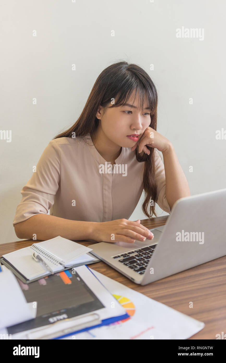 Vertical photo of young employee thinking about her work Stock Photo ...