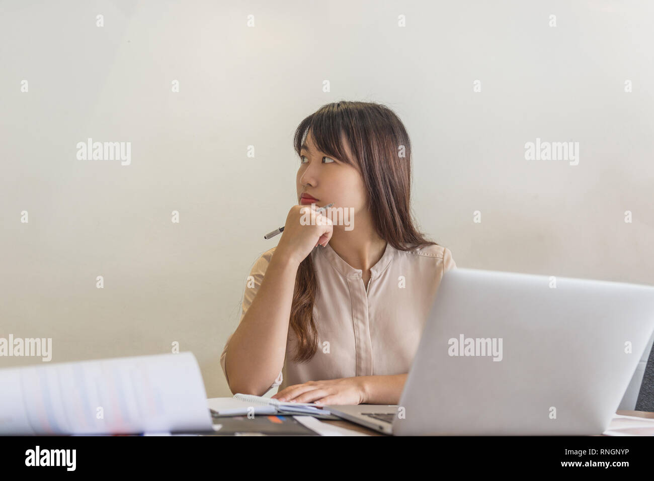 Woman employee thinking about new ideas for work Stock Photo - Alamy
