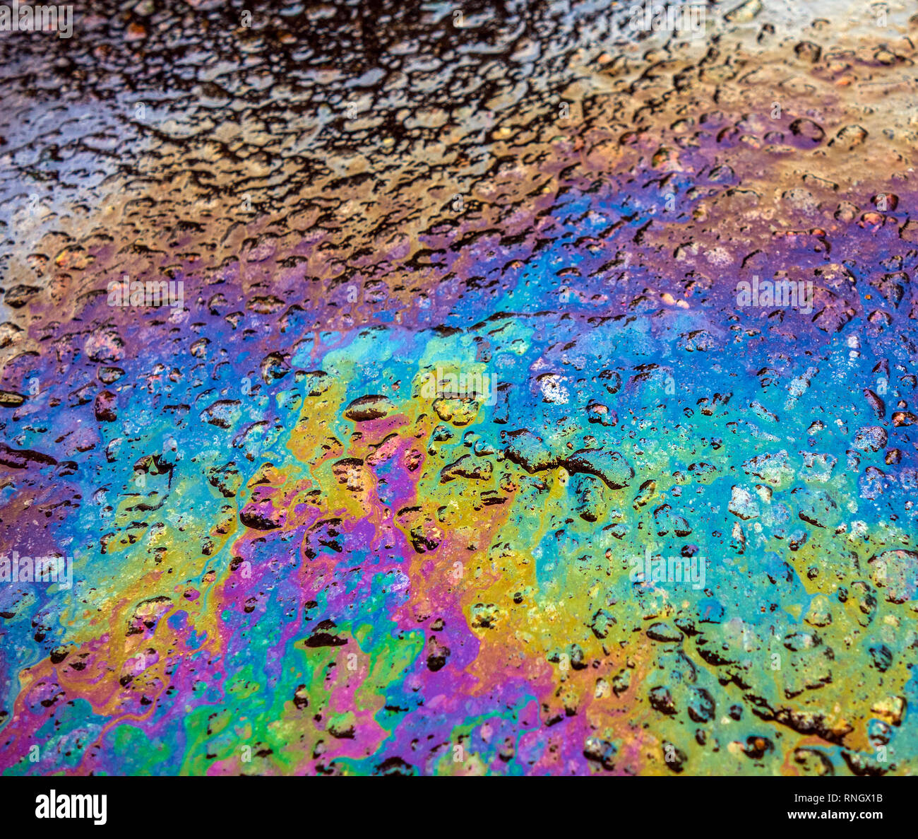 Gasoline Petrol Oil Spill Rainbow on Tarmac Road Stock Photo - Alamy
