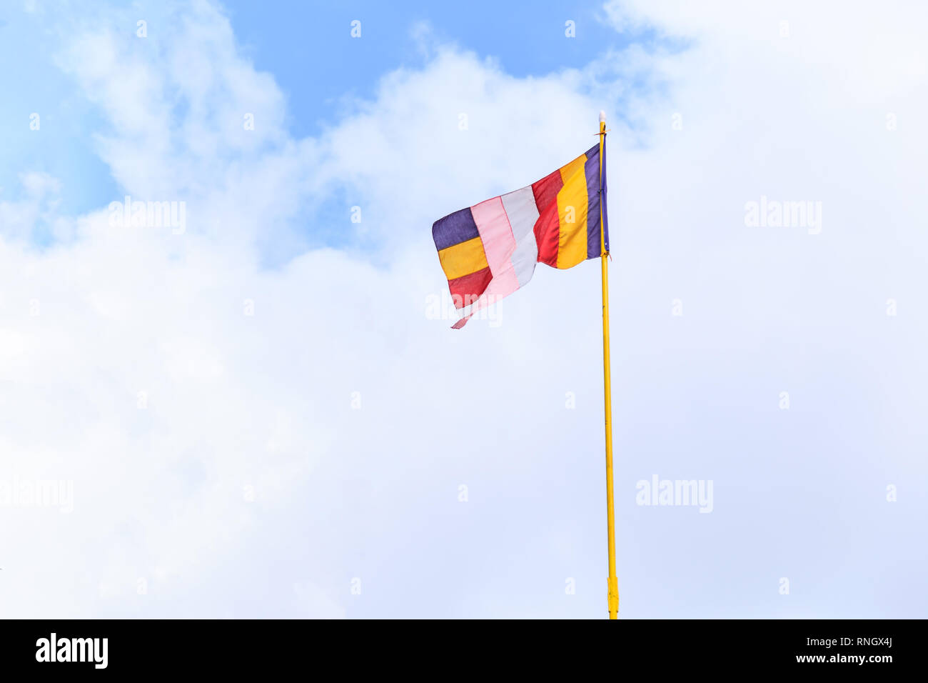 Wind Wavering colorful Buddhist flag in Buddhist temple with blank blue ...