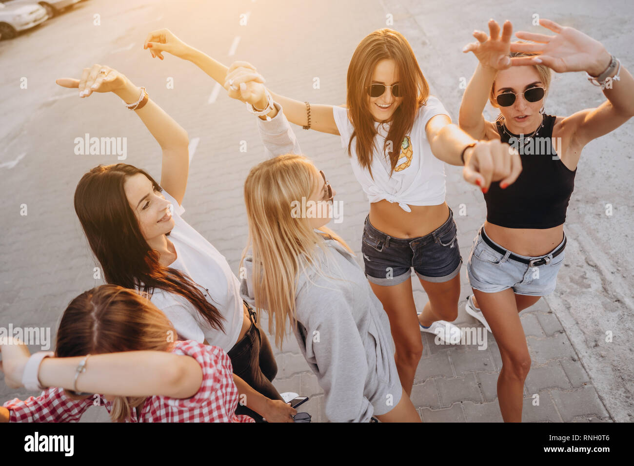 Five young women dance in a car park Stock Photo - Alamy