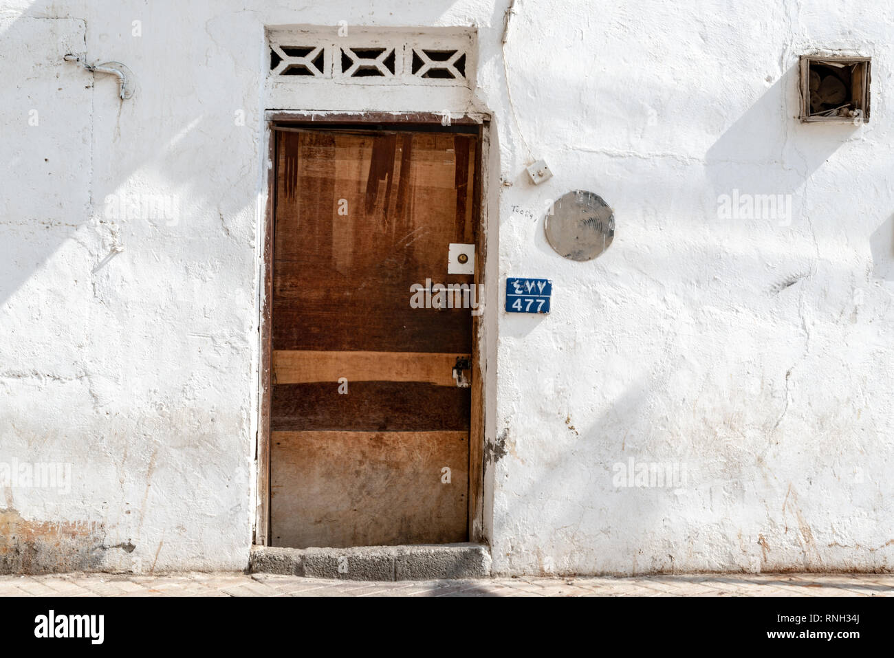 Brown entrance door of a building in the historical district of Matrah ...