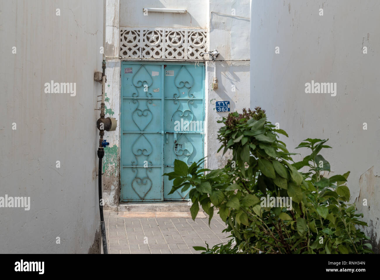 Blue entrance door of a building in the historical district of Matrah ...
