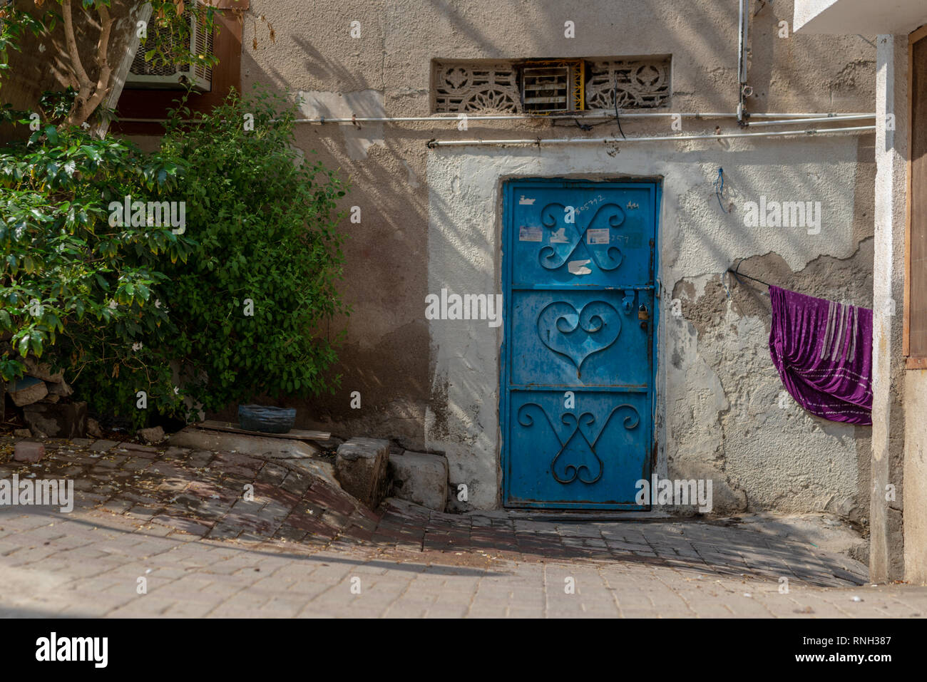 Blue door and hanging clothes in the historical district of Matrah ...