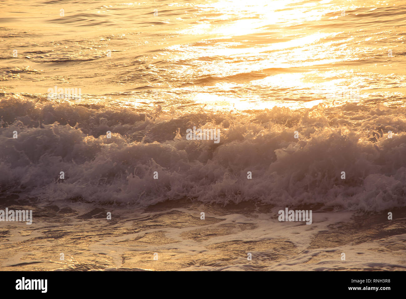 Sunlight Reflected On Water Waves In The Beach Stock Photo - Alamy