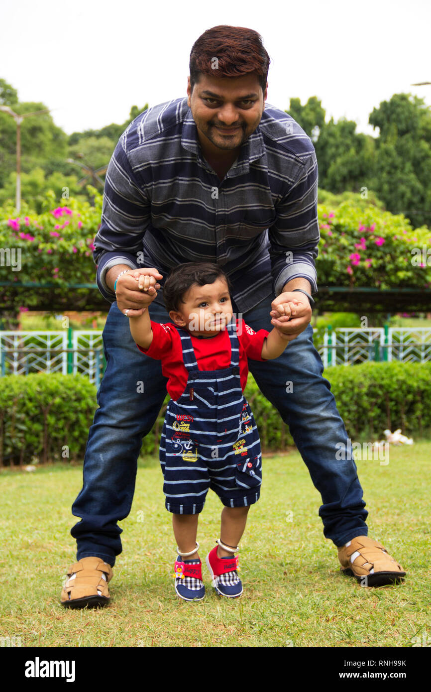 Child helping toddler walk hi-res stock photography and images - Alamy