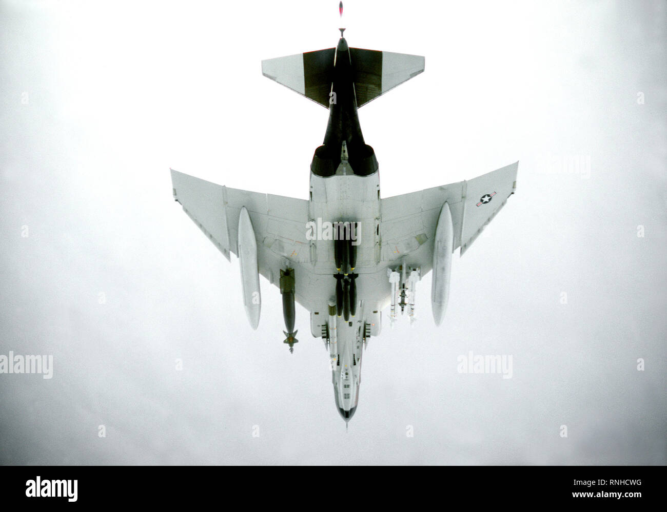 1980 - An underside view of an F-4E Phantom II aircraft in flight ...