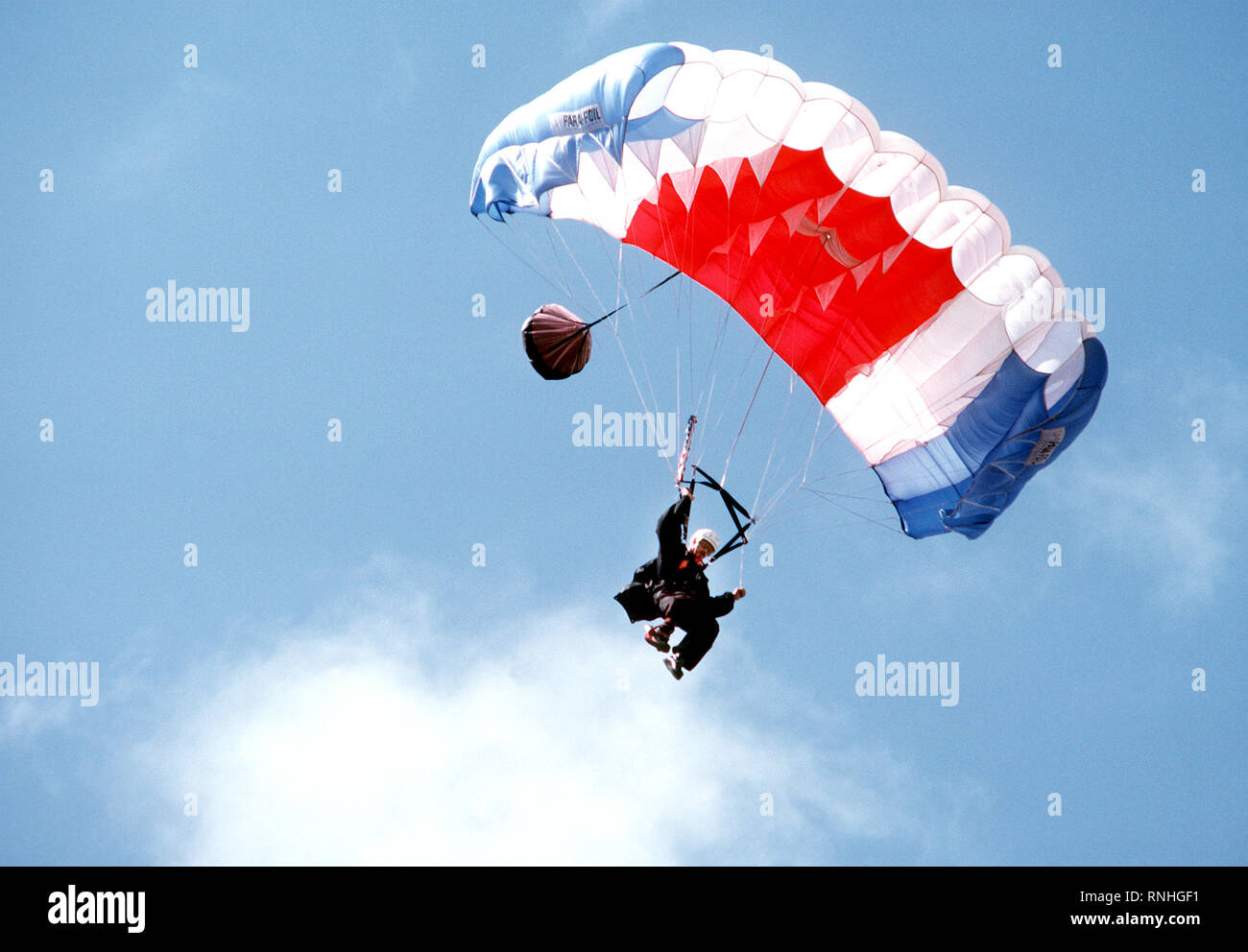 A member of the 193rd Command Parachute Team displays his skill in a ...