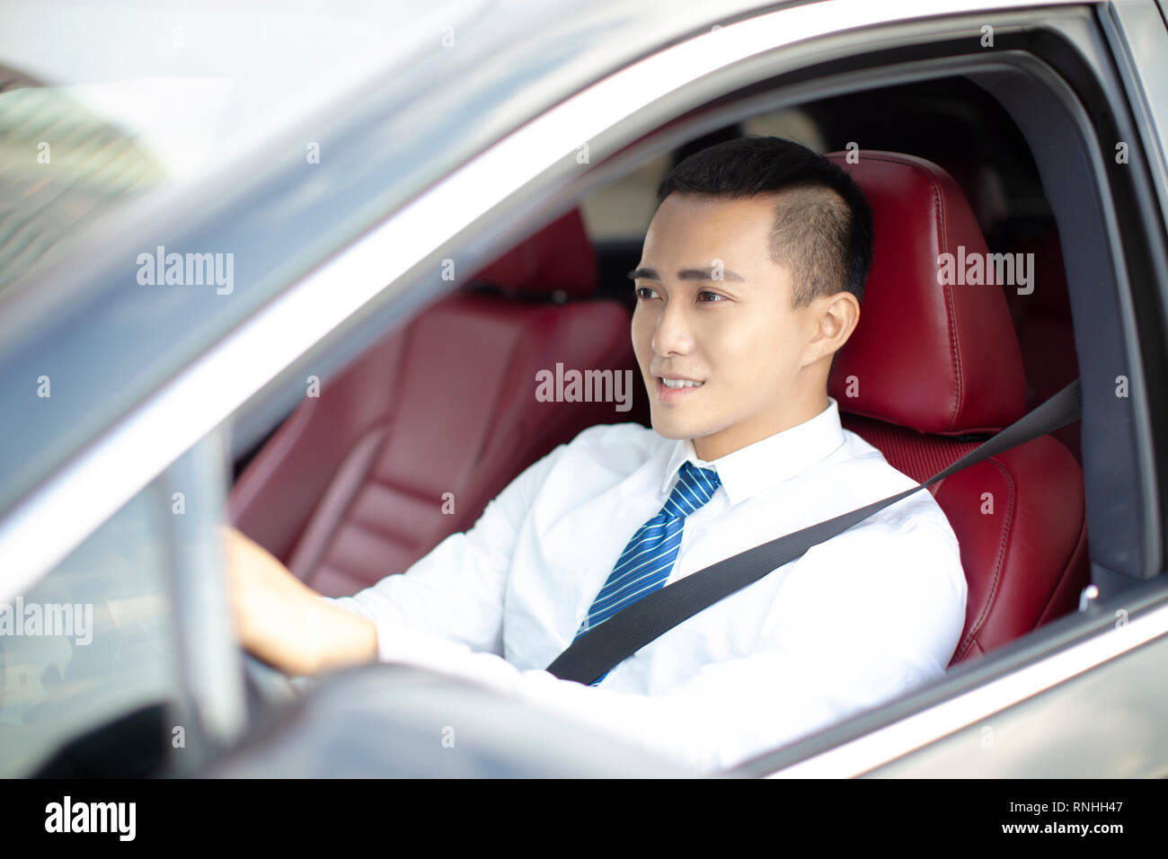 Young chinese man driving car hi-res stock photography and images - Alamy